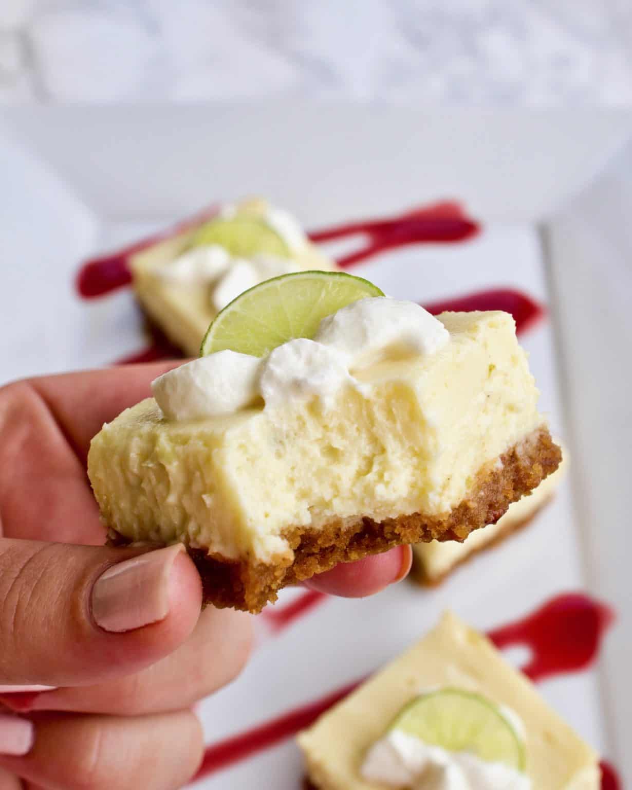 Key Lime Cheesecake Bars with Raspberry Sauce - Yummy Noises